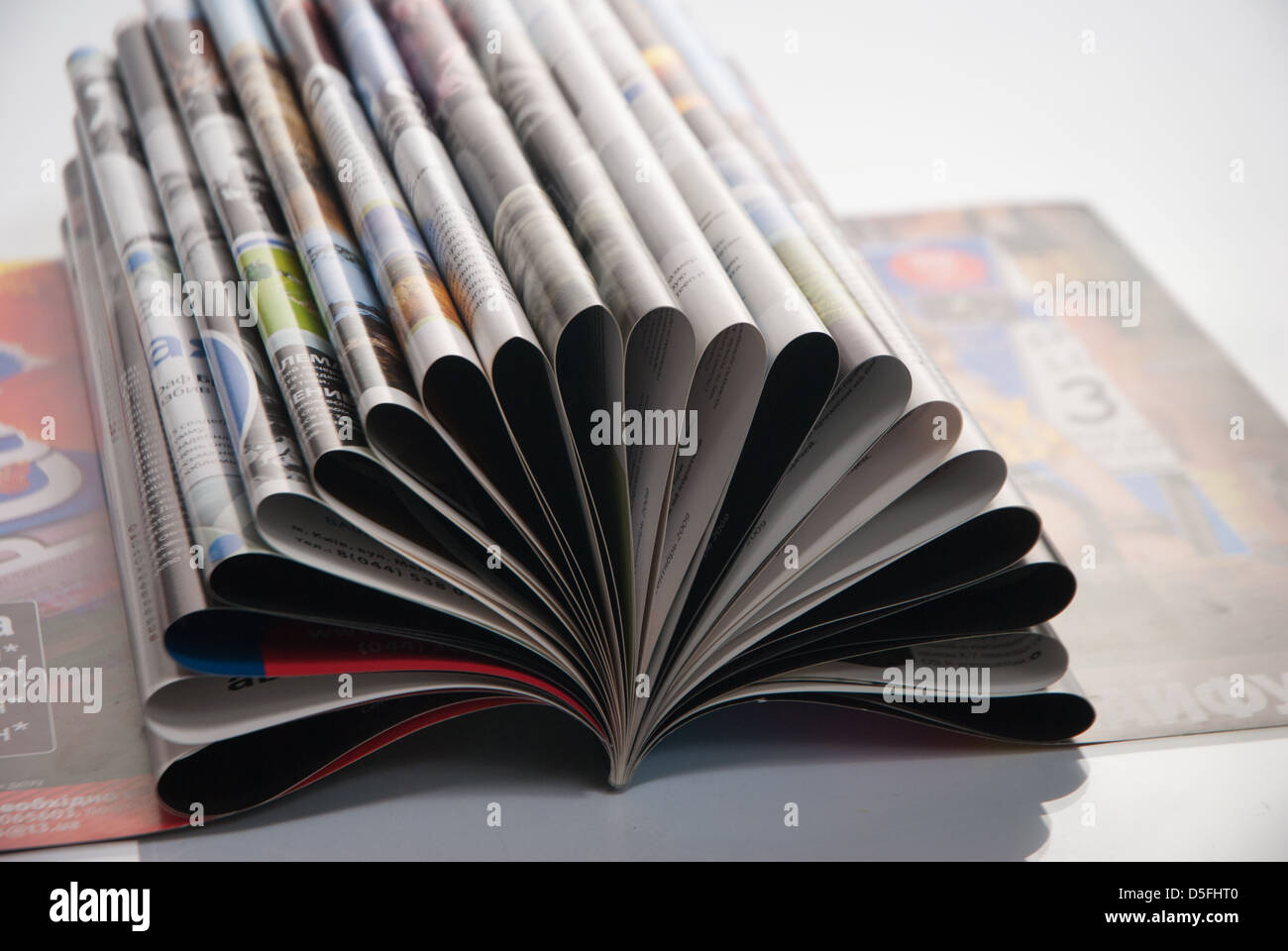 Open magazine with curled pages. Close-up Stock Photo - Alamy