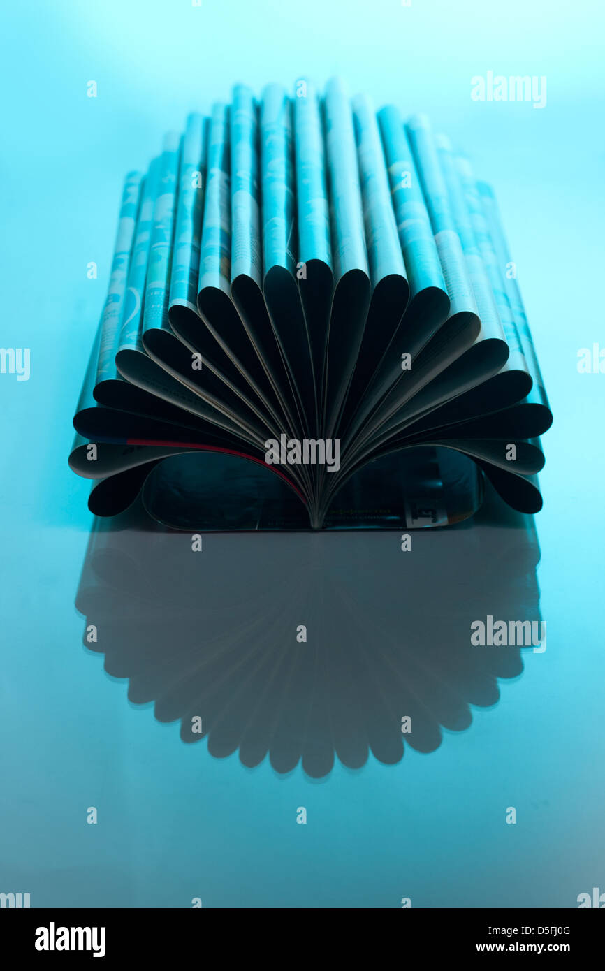 Open magazine with curled pages. Close-up Stock Photo - Alamy