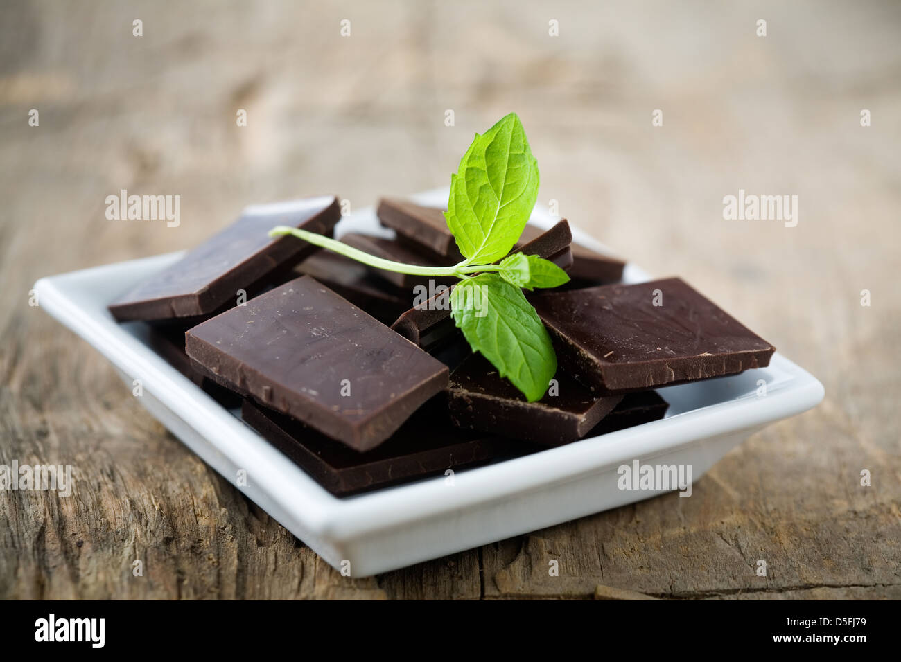 Dark chocolate blocks with fresh mint leaves Stock Photo - Alamy
