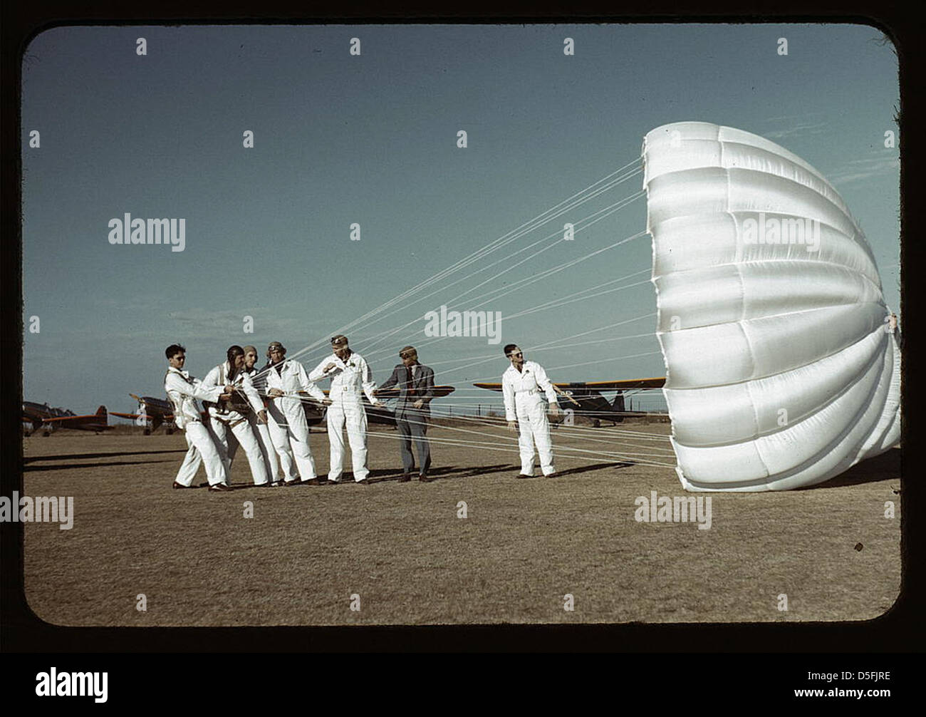 An instructor demonstrates parachute operation to student pilots at ...