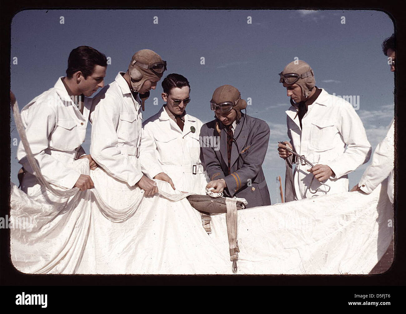 This image shows an instructor explaining the operation of a parachute ...