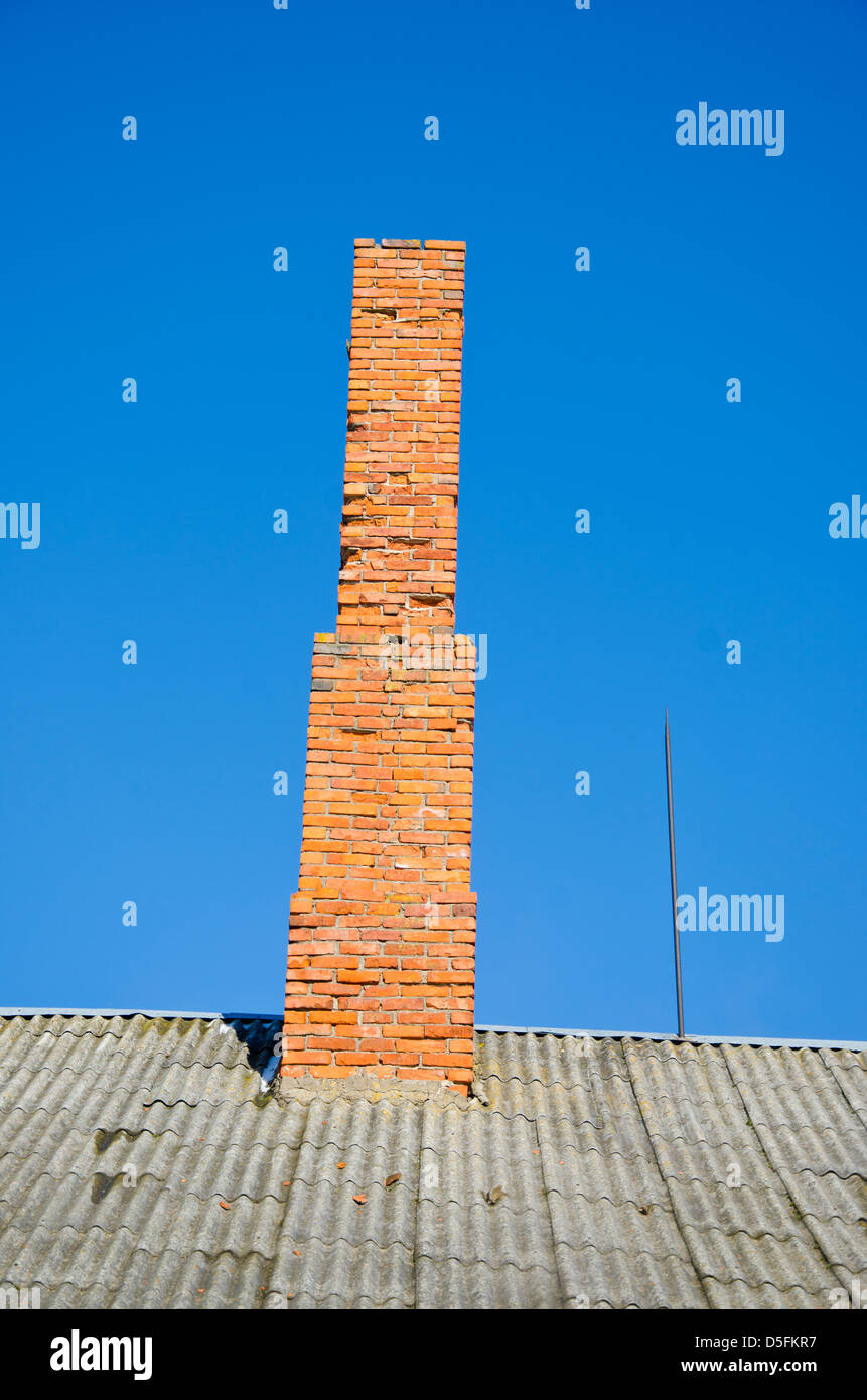 old red bricks chimney on roof and blue sky background Stock Photo - Alamy
