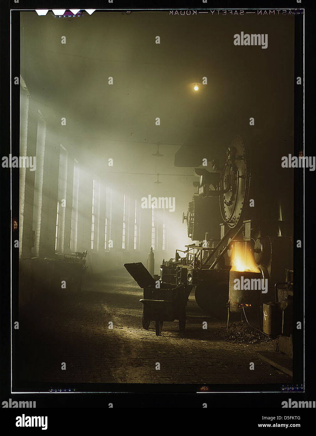 This image from 1942 shows the interior of a roundhouse at a railroad ...