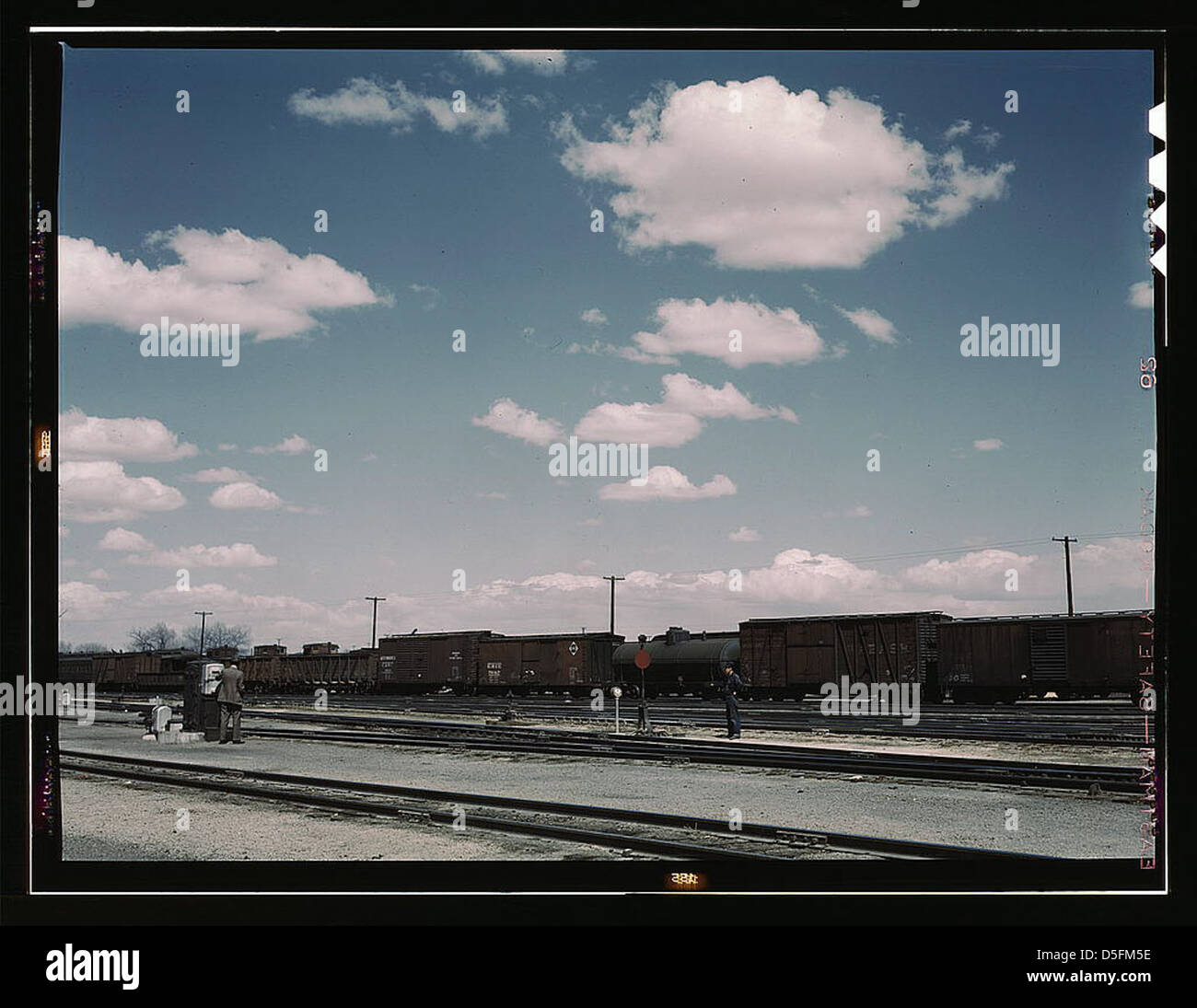 This 1943 photograph by Jack Delano depicts the Santa Fe Railroad yards in Belen, New Mexico. It ...
