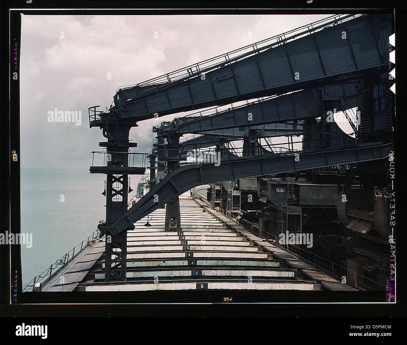 A photograph showing the unloading of iron ore from a lake freighter at ...