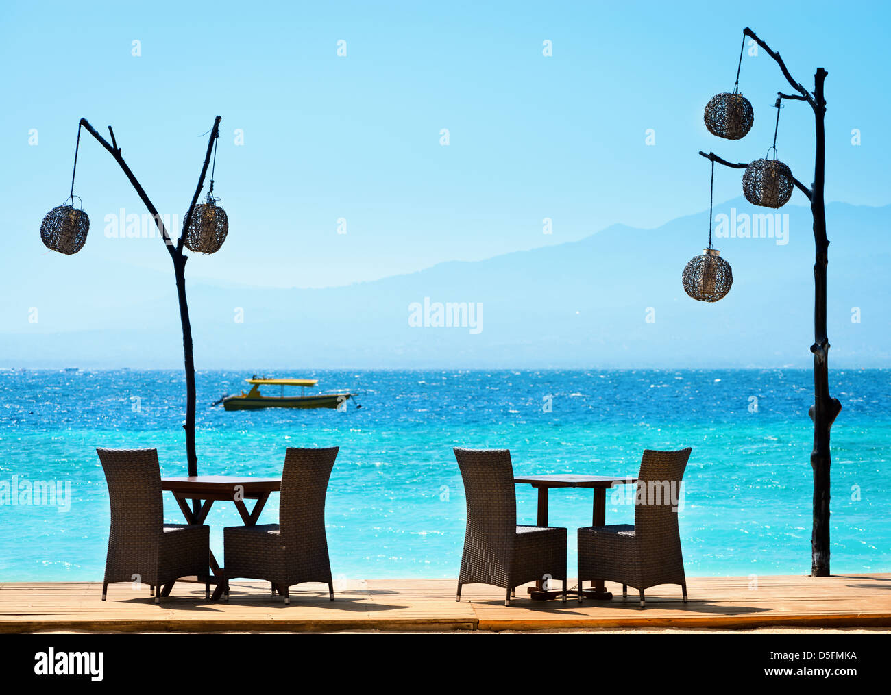Outdoor cafe on the beach with blue ocean and sky on background Stock ...