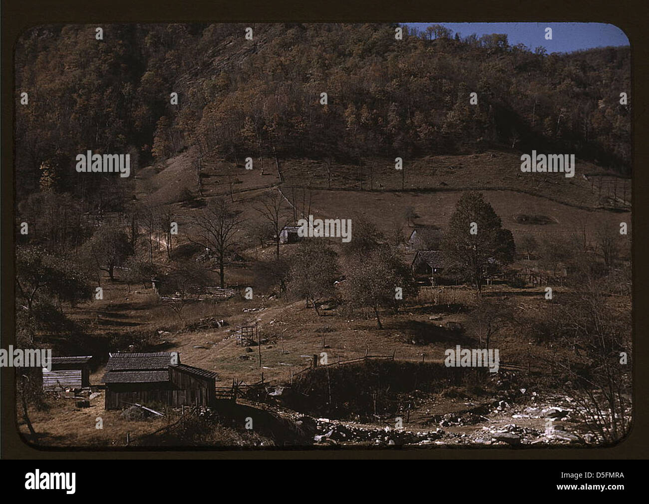 A photograph from 1940 showing a rural dirt road and homestead in the ...
