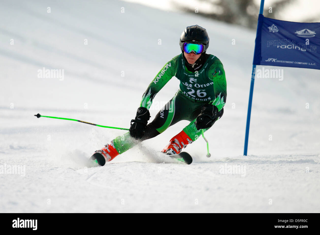 An alpine skier at a gate while racing on the giant slalom course Stock ...