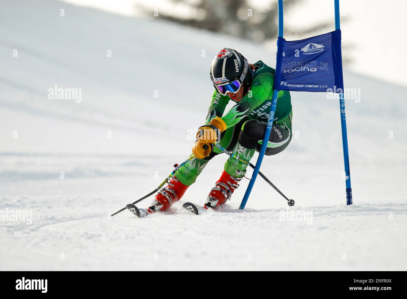 An alpine skier at a gate while racing on the giant slalom course Stock ...