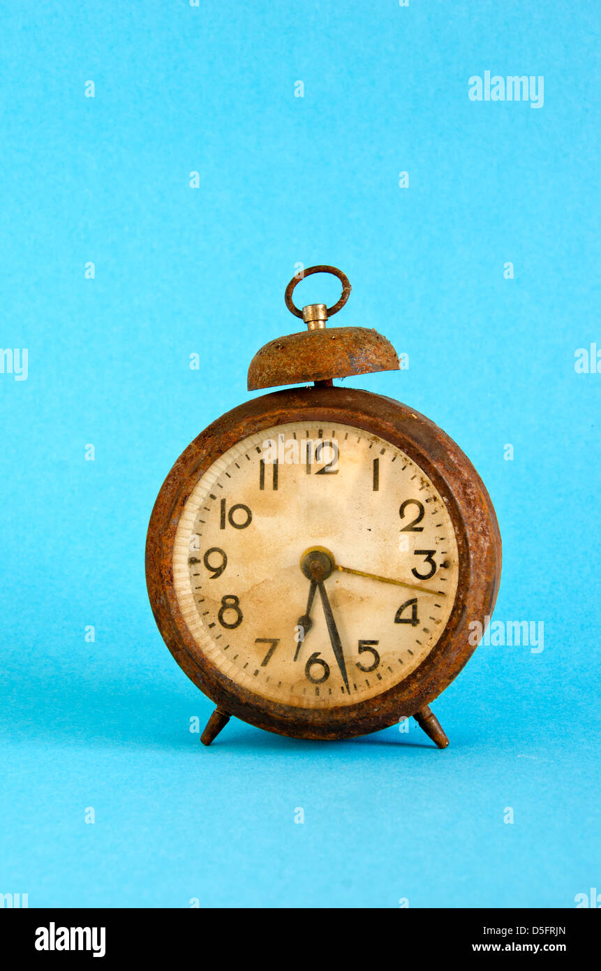 old rusty and grunge alarm clock on azure background Stock Photo - Alamy