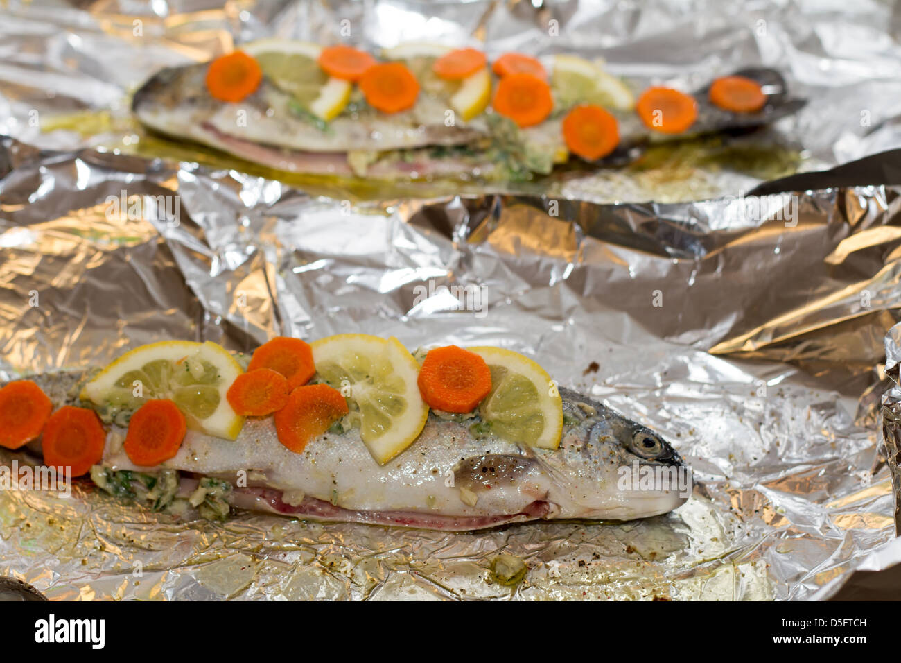 Trout fish with lemon slices and boiled potatoes Stock Photo - Alamy