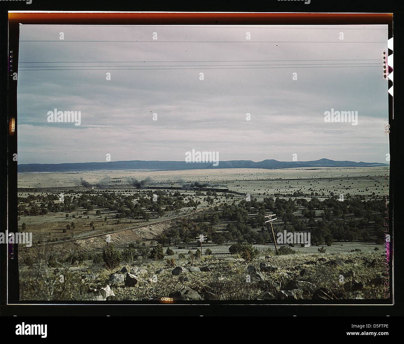 A 1943 photograph of a west-bound passenger train rounding a curve on ...