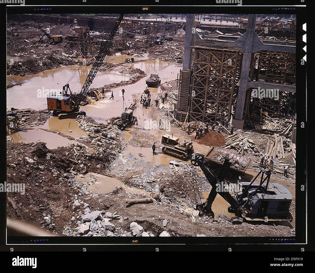 The photograph shows workers constructing the Douglas Dam in Tennessee ...