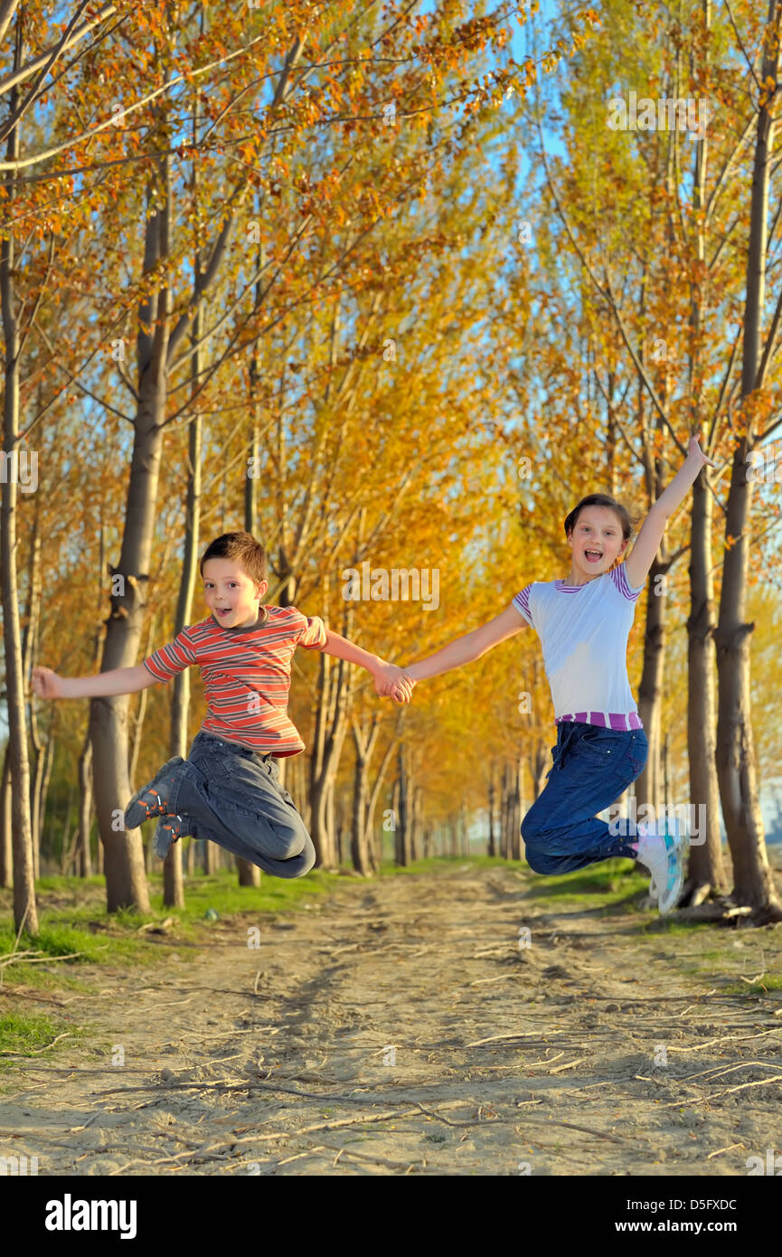 children play in forest in autumn time Stock Photo - Alamy