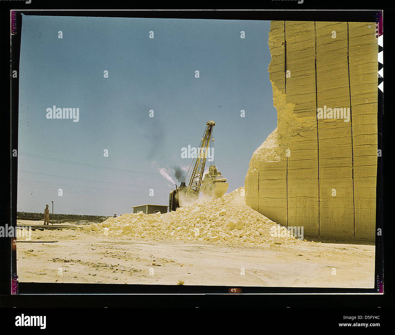 An image showing workers loading sulphur from a vat at Freeport Sulphur ...