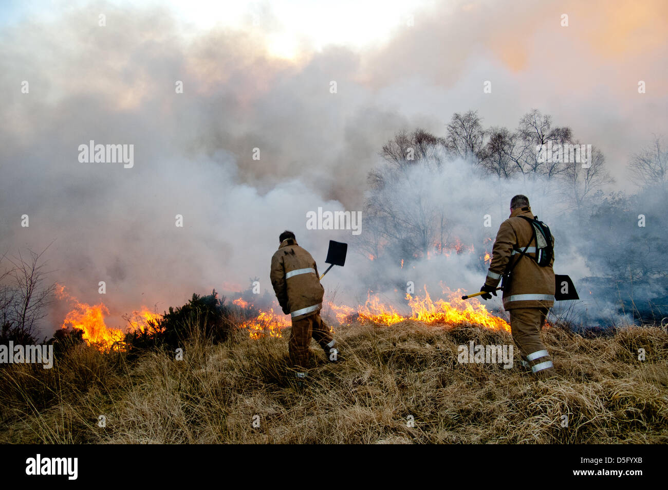 Fireman beating fire hi-res stock photography and images - Alamy