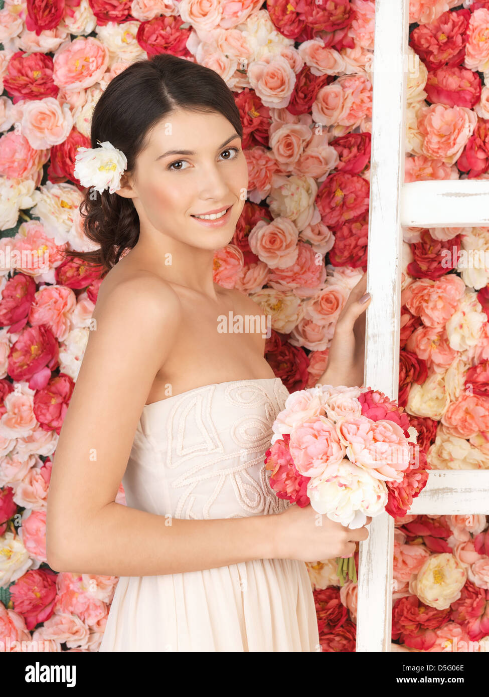 woman with bouquet and background full of roses Stock Photo - Alamy