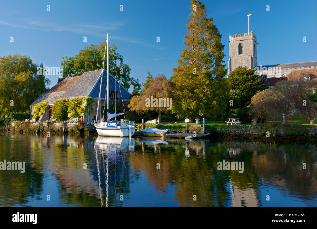 River Frome in Wareham, Dorset with Lady St. Mary Church in background ...