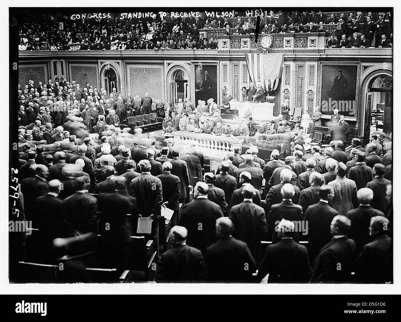 This historical photograph shows the U.S. Congress in 1913, standing to ...