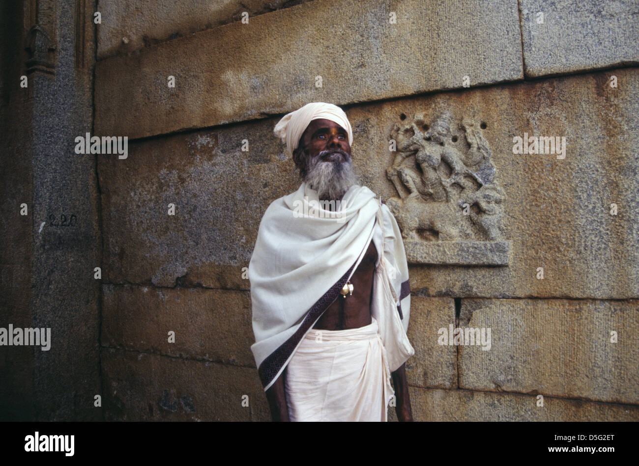 A Pujari or Hindu priest wearing traditional outfit posing in front of ...