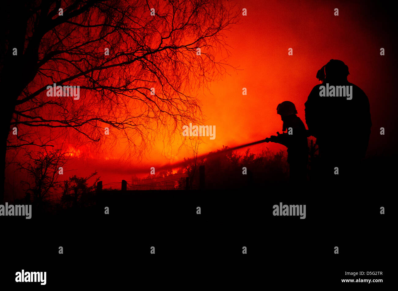 Fireman behind flames hi-res stock photography and images - Alamy