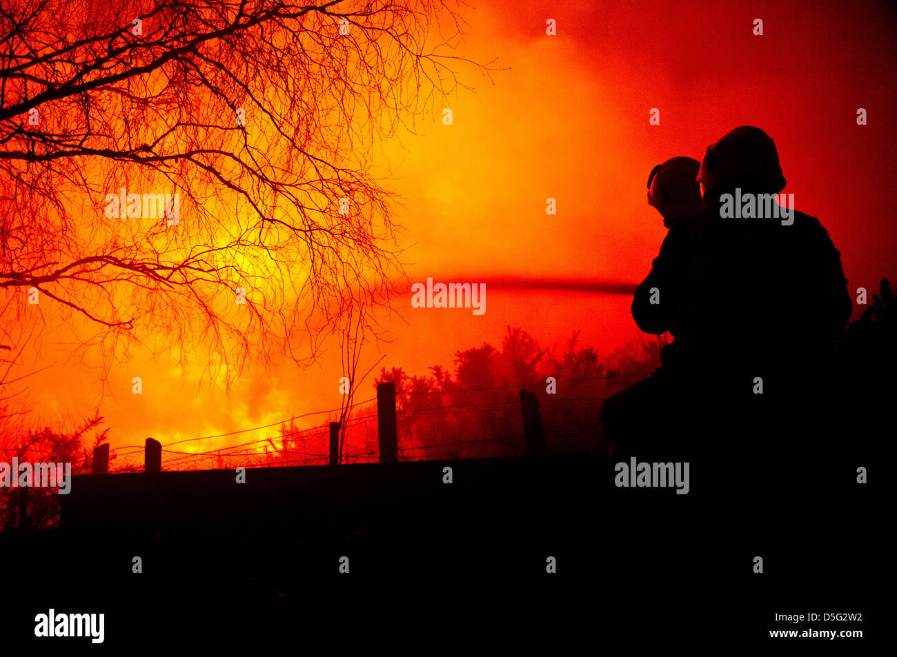 Fireman behind flames hi-res stock photography and images - Alamy