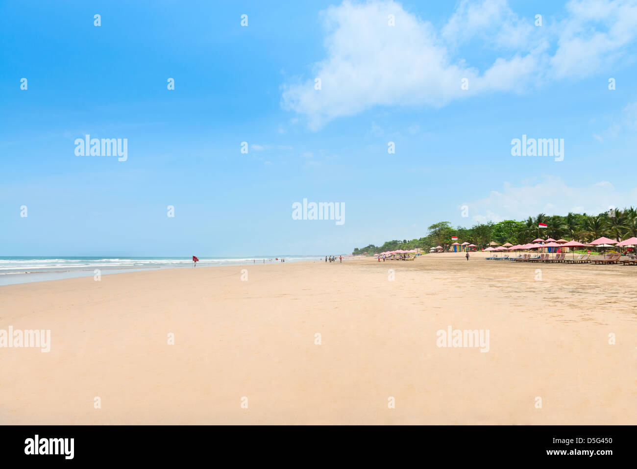 Wide sand beach with tourists, umbrellas and beds. The five km long ...