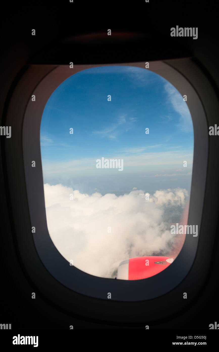 Cloudy blue sky through open airplane window Stock Photo - Alamy