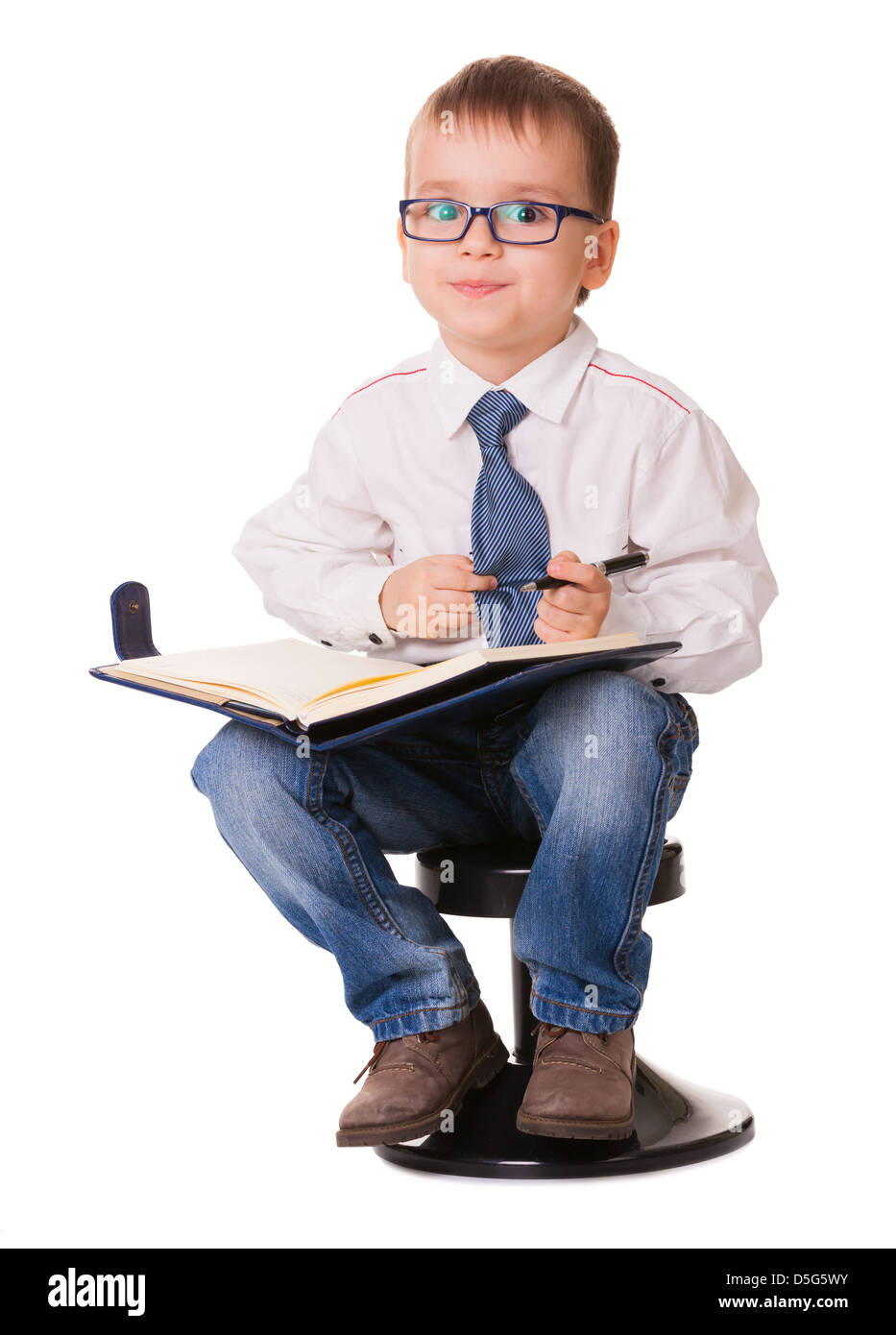 Small clever kid with organizer notebook and pen looking in camera ...