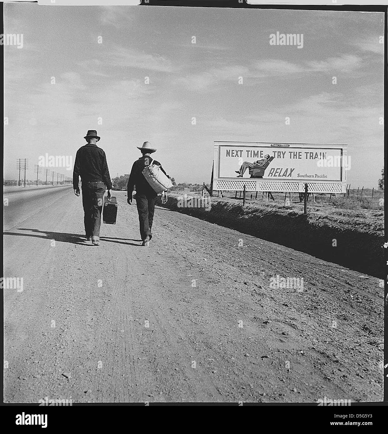 This 1937 photograph, taken by Dorothea Lange, depicts a dirt road ...