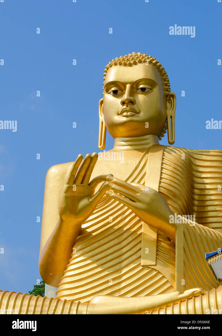 Golden yellow Buddha statue on blue sky background Stock Photo - Alamy