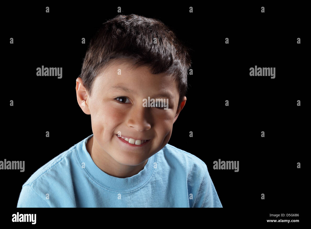 Smiling boy on black background with dramatic side lighting Stock Photo ...