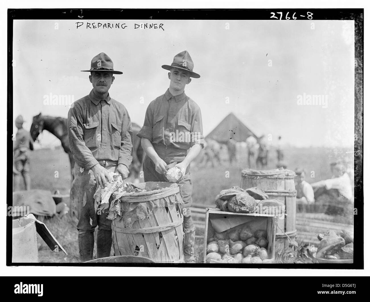 A photograph of National Guard soldiers preparing dinner during a ...