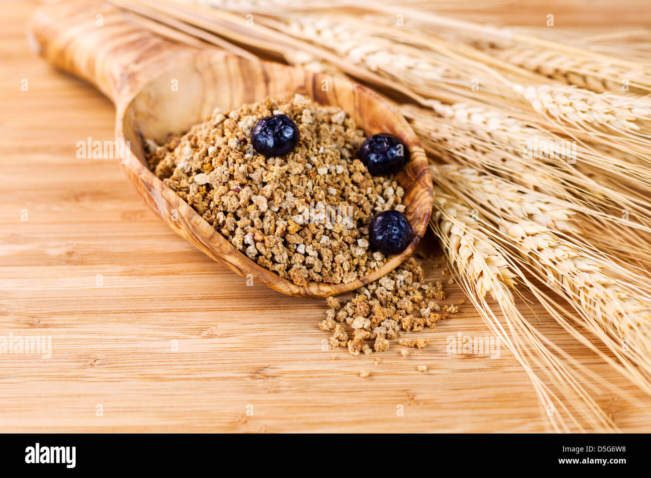 Natural whole gain cereal in wooden spoon on bamboo wood with wheat ...