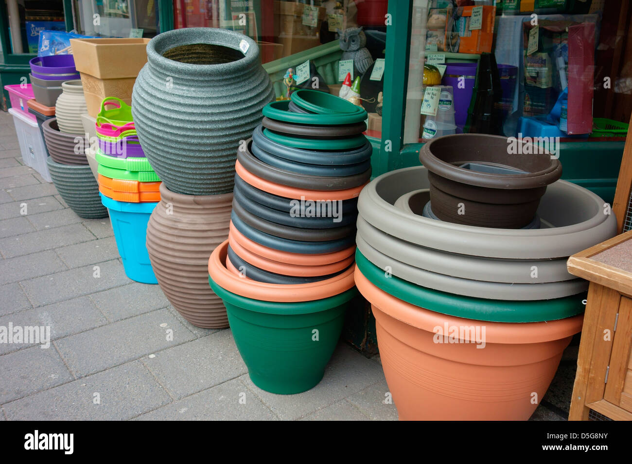 Plastic plant pots on display in the street outside hardware shop Stock ...