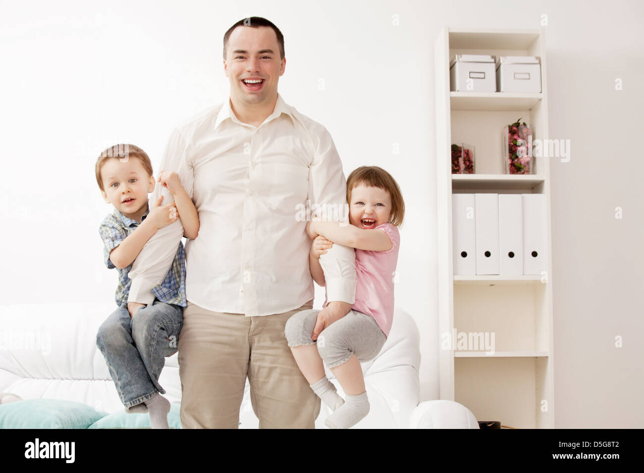 Portrait of a happy young guy with kids Stock Photo - Alamy