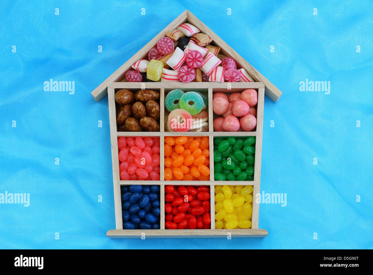 Selection of candies and sweets in wooden box on blue background Stock ...