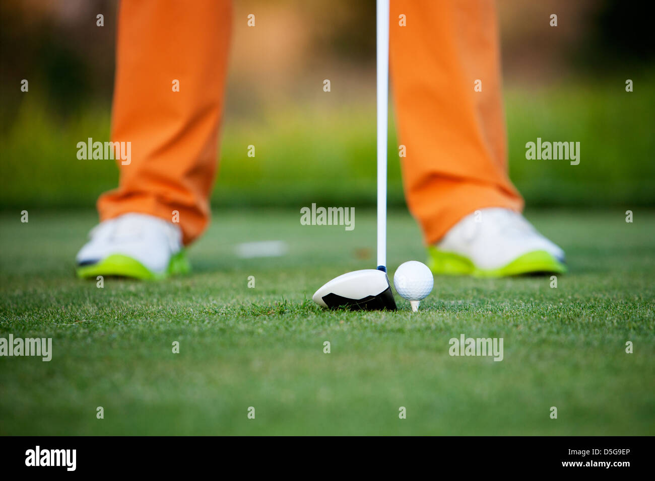 Male golfer shooting a golf ball from green grass Stock Photo - Alamy