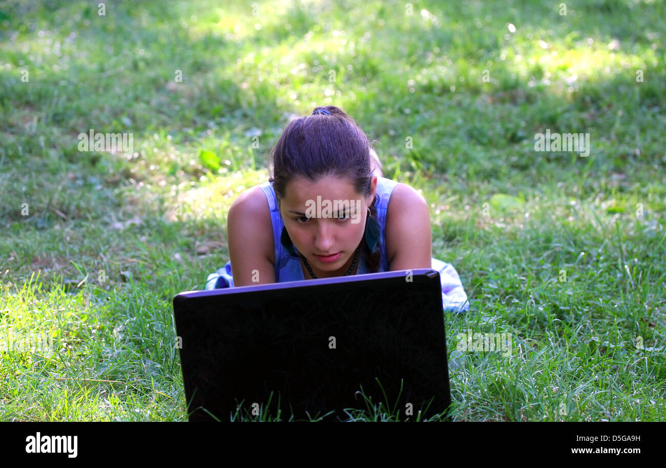 Beautiful girl outdoors with laptop Stock Photo - Alamy