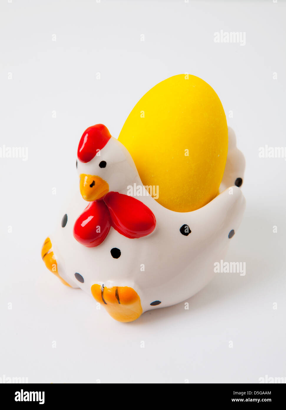chicken ceramic egg cup with yellow sugar easter egg Stock Photo - Alamy