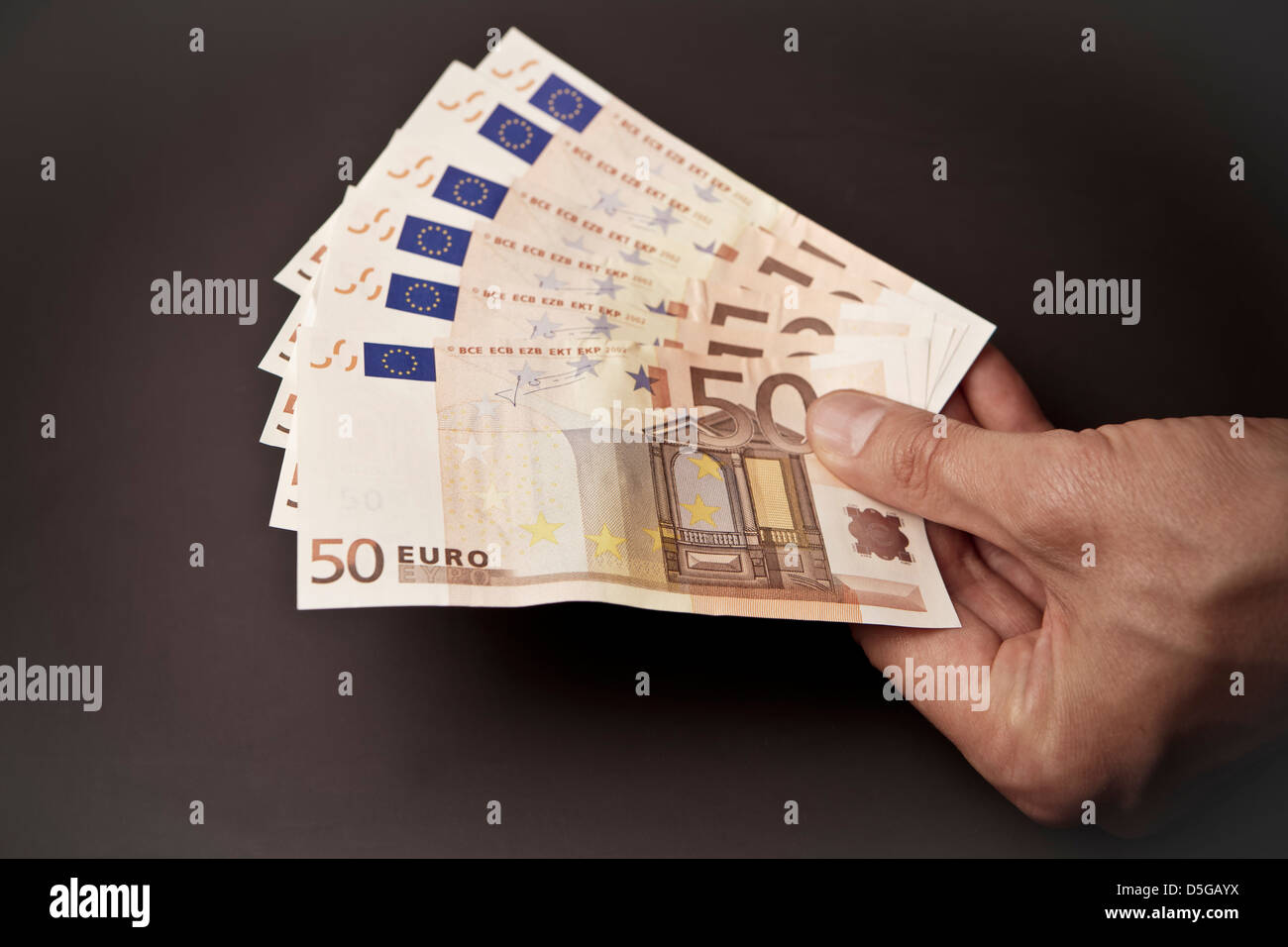 hand with euros Stock Photo - Alamy