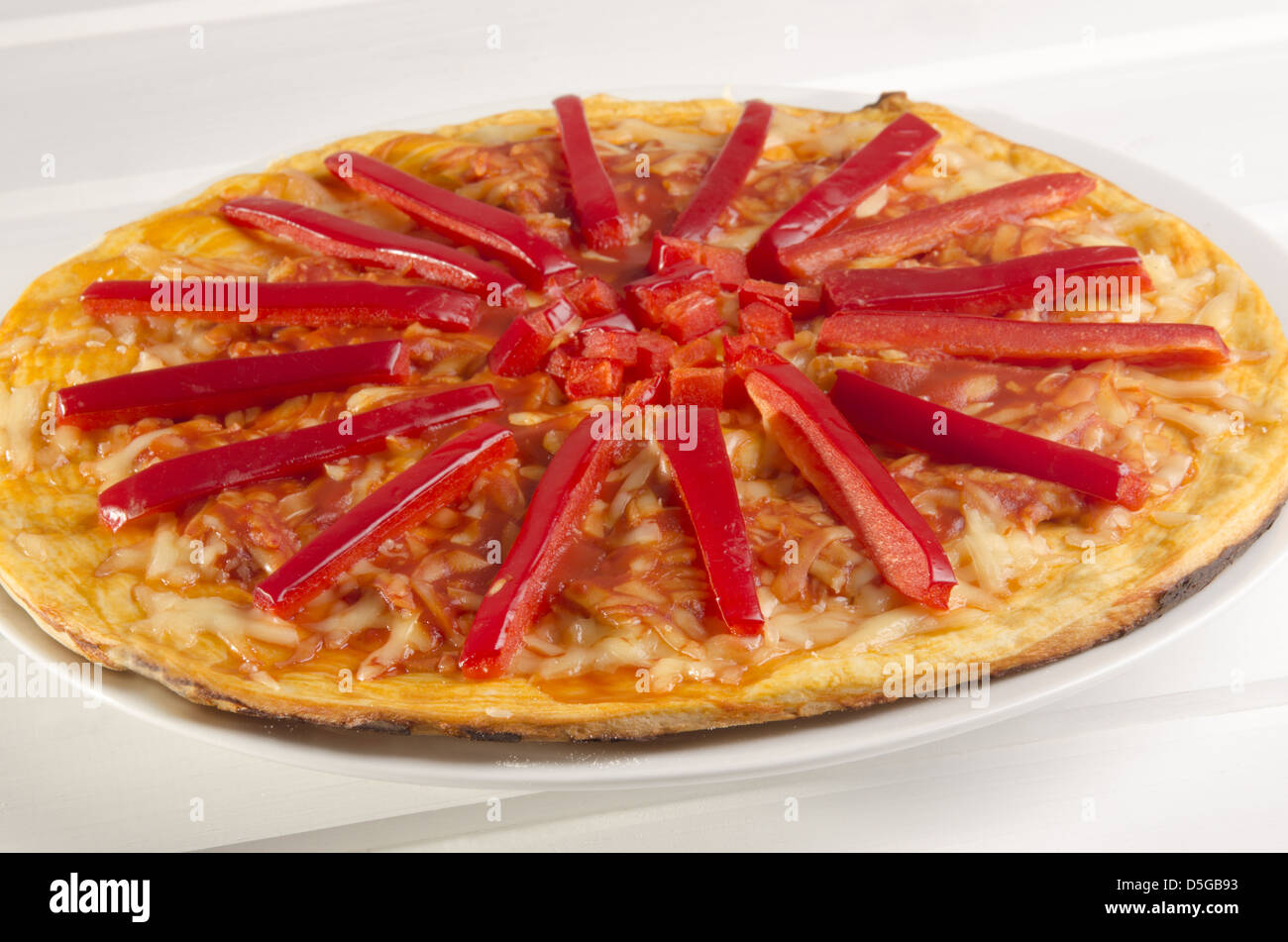 pizza with red pepper stripes and grated cheese Stock Photo - Alamy