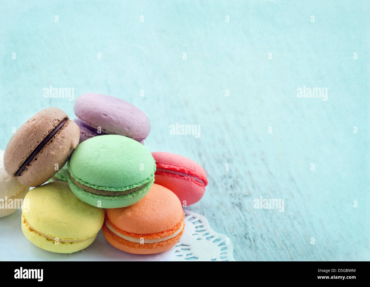 Group of pastel color macaroons on blue textured shabby chic background ...