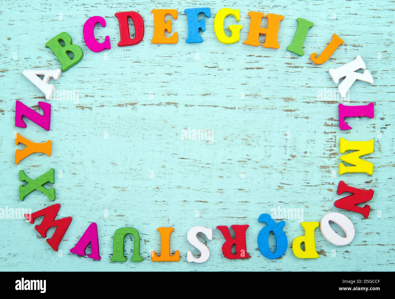 Colorful alphabet letters with copy space, on light blue wooden ...