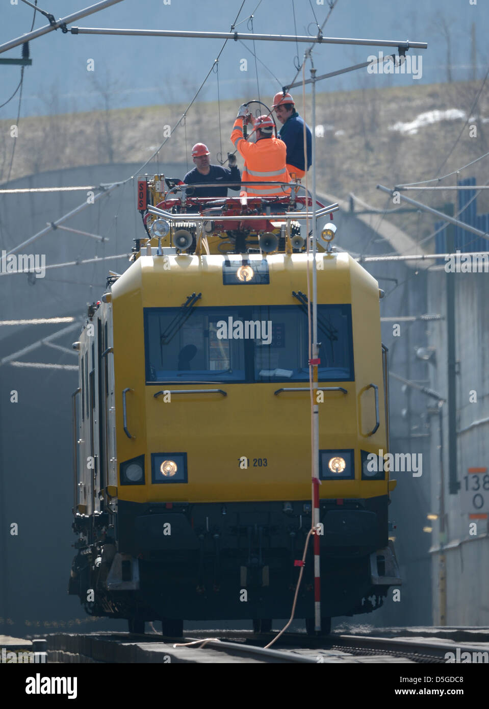 Workers of the German railways repair the overhead wire in front of the ...