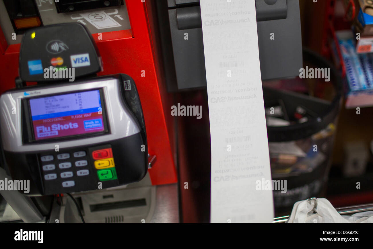 A long receipt exits a self service register at a CVS Pharmacy store in ...