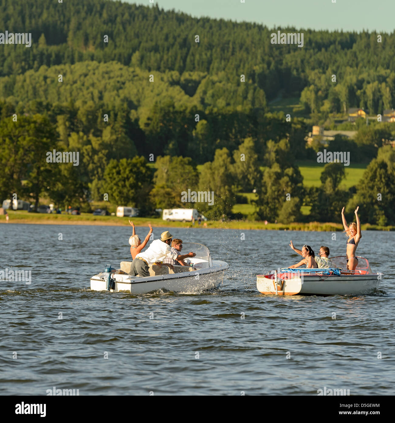 Friends having fun lake splashing hi-res stock photography and images ...
