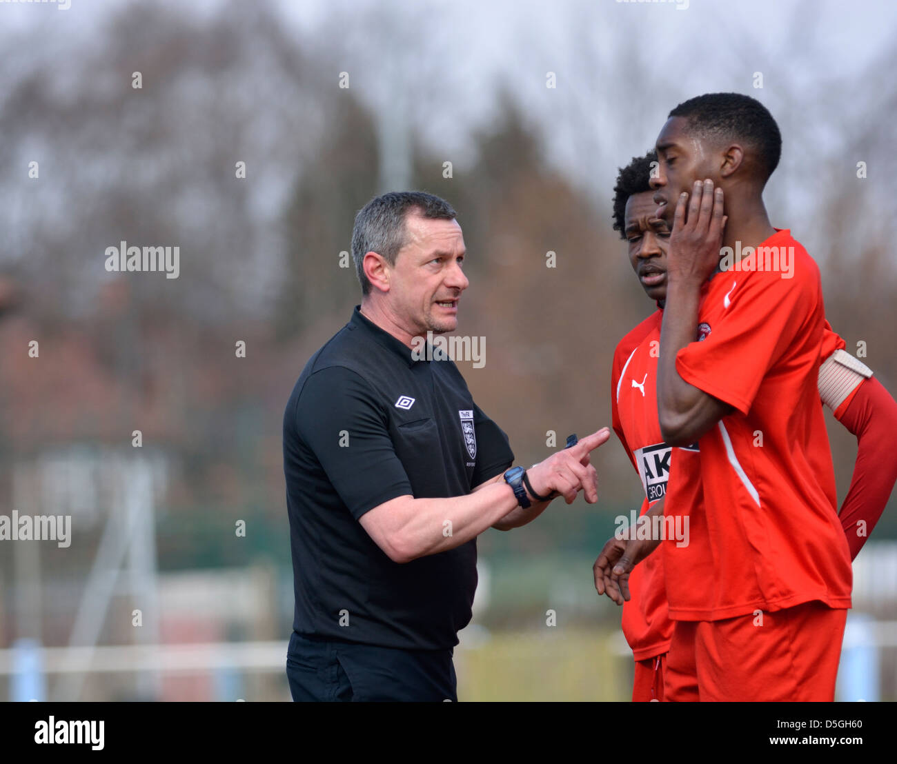 the referee gives a warning to a football player Stock Photo - Alamy