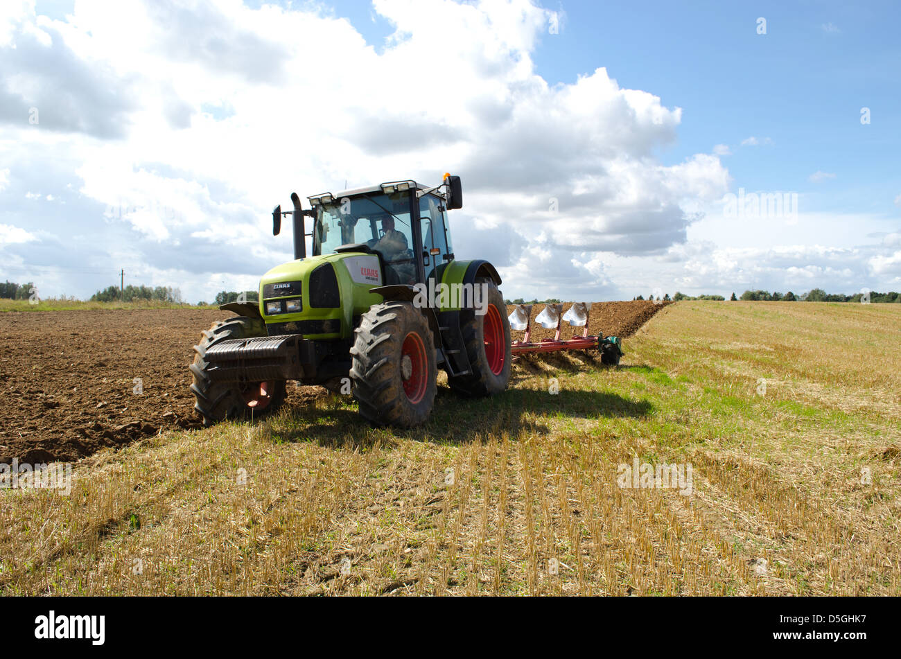 heavy agriculture machine tractor plow work field in august on circa ...