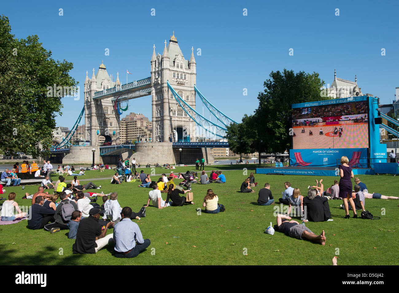 Crowds watching the 2012 London Olympics on a large screen by Tower ...